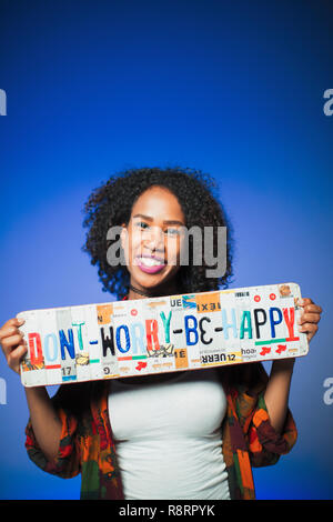 Dont worry, just be happy. Portrait of a smiling young woman alone at ...