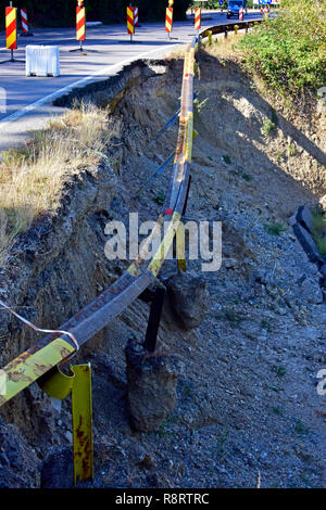 Road embankment rupture and guardrail failure caused by landslide on ...