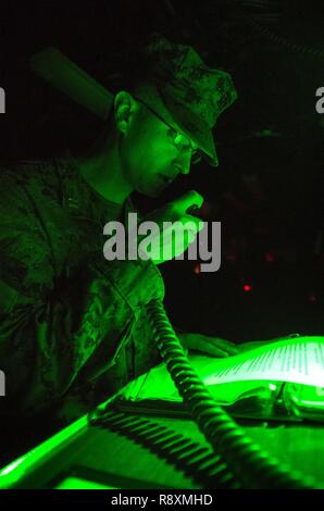 US Navy Navy Chaplain, reads a prayer during a church service in the ...