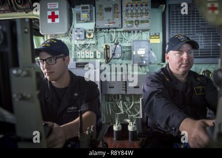 US Navy Bridge watchstanders work together to hold a steady course ...