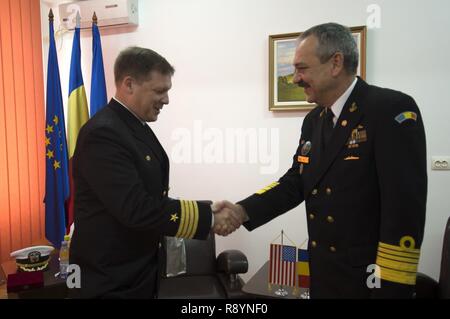 US Navy Commodore right, presents a certificate of appreciation to ...