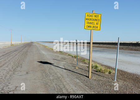 Road Not Maintained Travel at Own Risk sign along remote desert road ...