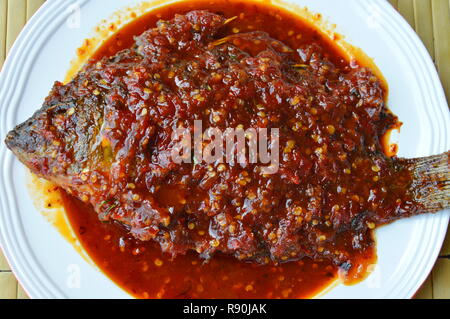 deep fried black mango fish dressing chili sauce on plate Stock Photo ...