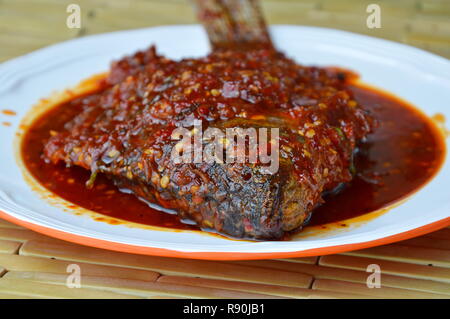 deep fried black mango fish dressing chili sauce on plate Stock Photo ...