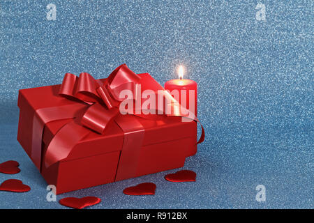 Gift with candle, ribbon and hearts on red background. Valentine's Day ...
