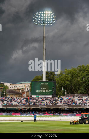 After heavy rain at Lords cricket ground the ground staff use a ...