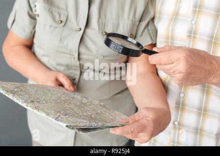 Portrait of adult tourists standing with map at street in hats Stock ...
