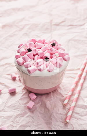 Hot chocolate with marshmallow and paper snowflakes on blue background ...