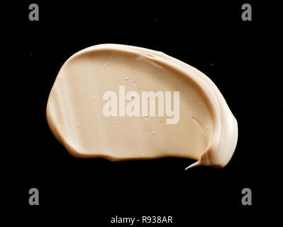 the texture of a foundation liquid. Black background Stock Photo - Alamy