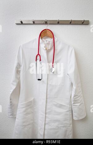 Doctors Lab Coat hanging on door Stock Photo - Alamy