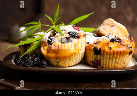 Muffins with marijuana and berry fruit top view Stock Photo - Alamy