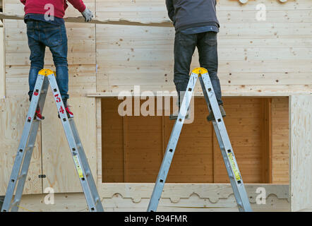 two ladders on building Stock Photo - Alamy