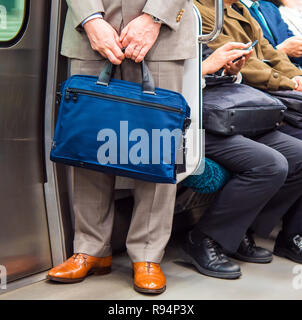 Selective focus of man in suit holding bottle of wine near elegant ...