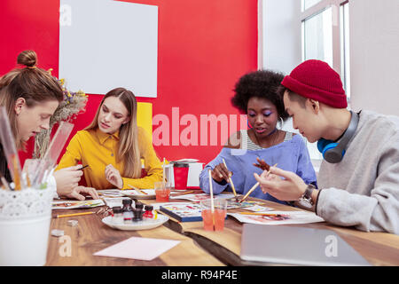 Talented creative art students feeling happy working together Stock ...