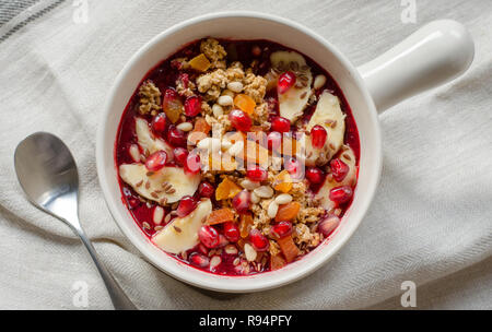Smoothie acai bowl topped with pomegranate, bananas, flaxseeds, cedar ...