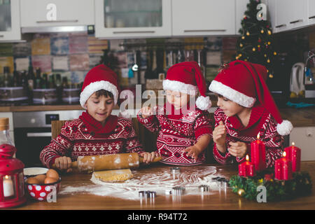 Sweet toddler child and his older brother, boys, helping mommy ...