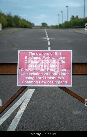 Barrier with sign warning trespassers Stock Photo - Alamy