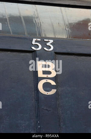 An Old And Repaired Wooden Door With Metal Hinges And Handle Stock ...