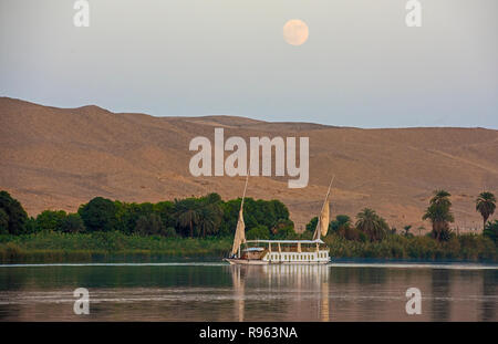 A dahabiya sailing on the river Nile Egypt, near the bank with palms ...