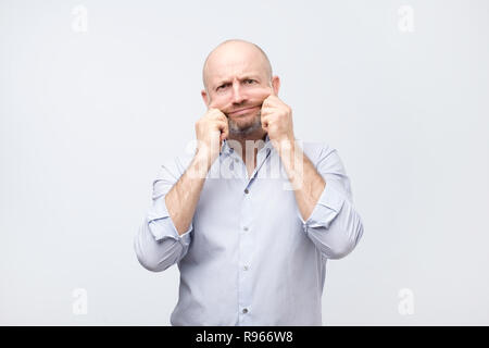 Man stretching skin on face Stock Photo - Alamy