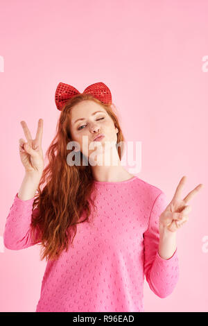 Wink, kiss and peace sign with portrait of woman in studio for support ...