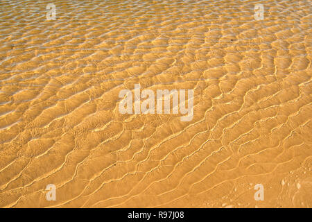 shallow surf with sand of a beach with patterns Stock Photo - Alamy