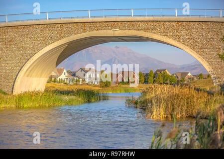 Arched bridge over Oquirrh Lake in Daybreak Utah Stock Photo - Alamy