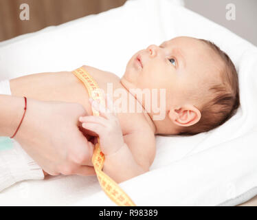 Close-up shot of pediatrician examines two months baby boy. Doctor ...