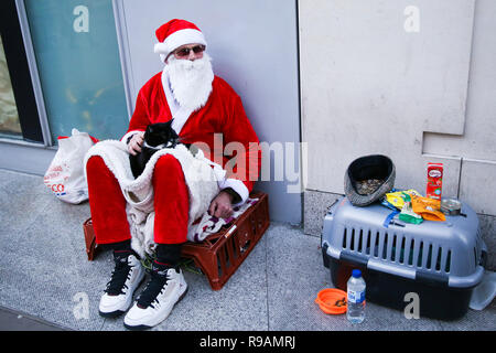 Homeless man dressed in a Santa Claus / Father Christmas suit selling ...