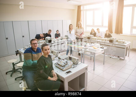 Group of young students in technical vocational training with young ...