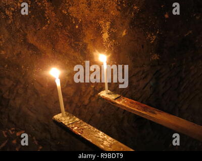 Candles light up the interior of the Taya Caves at Kamakura, carved ...