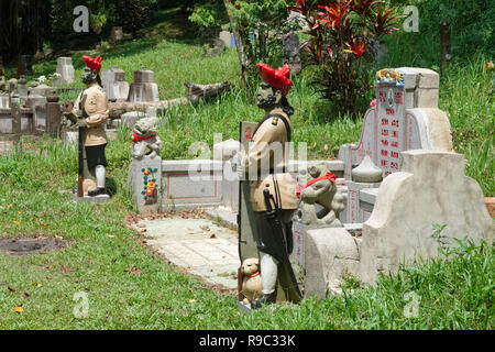 Figures of Sikh soldiers stand guard at a Chinese grave in Bukit Brown ...