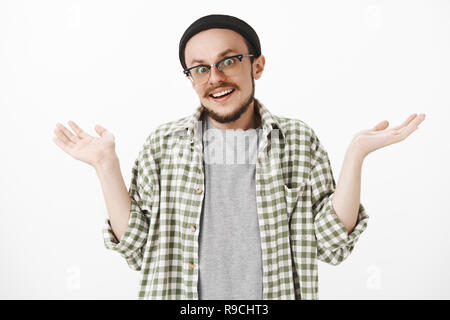 Careless and indifferent guy shrugging, looking unbothered, dont know ...