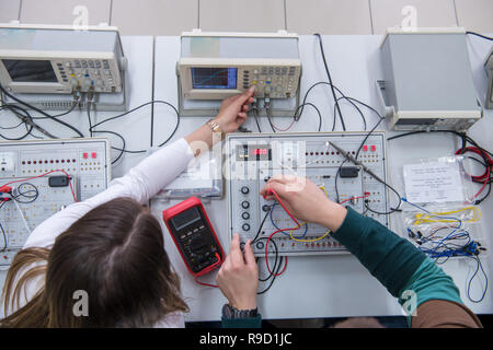 Group of young students doing technical vocational practice with ...
