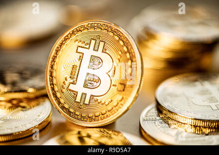 Shiny physical bitcoins on golden background. Blockchain technology ...