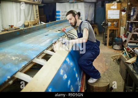 Handyman with industrial handtool repairing factory equipment Stock ...