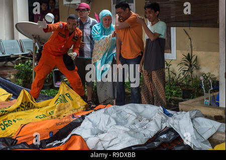 Relatives of nine victims killed in a bank robbery mourn outside the ...