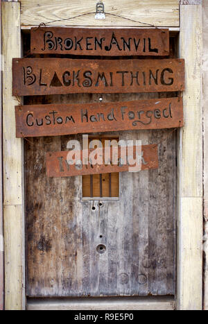 Hanging sign on a blacksmith workshop building Stock Photo - Alamy
