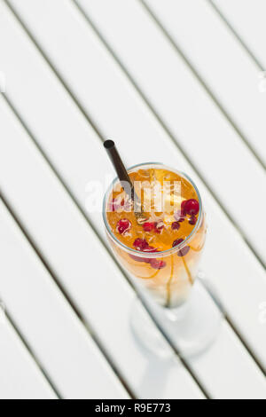 Cold lemonade with cranberries, ginger and ice on the outdoor veranda ...