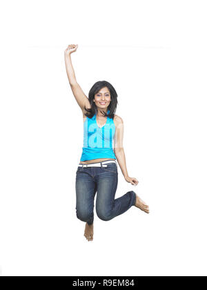 WOMAN JUMPING IN EXUBERANCE AGAINST A WHITE BACKGROUND Stock Photo - Alamy