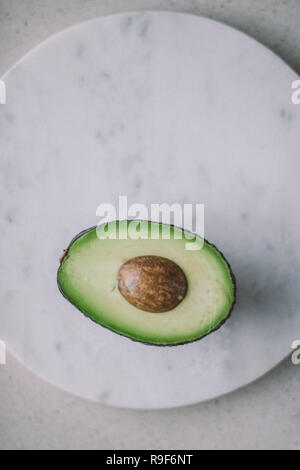 avocado on marble table - organic vegetables and healthy eating styled ...