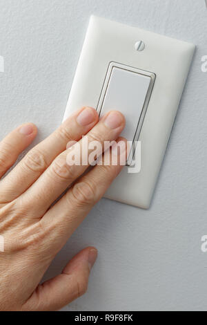 Hand turning on white electric radiator of a house in winter Stock ...