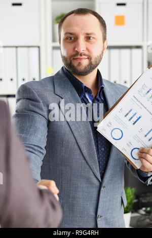 Smiling man in suit shake hands as hello in office Stock Photo - Alamy