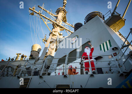A US Navy sailor dressed as Santa Claus directs aircraft movement ...