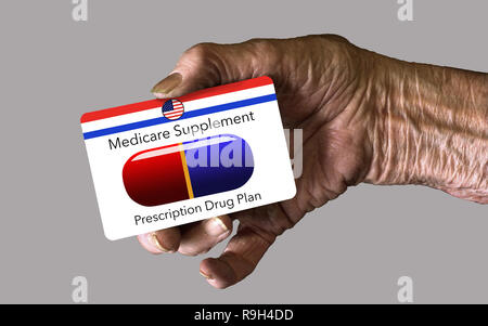 An elderly hand holds an insurance or benefits card such as social ...