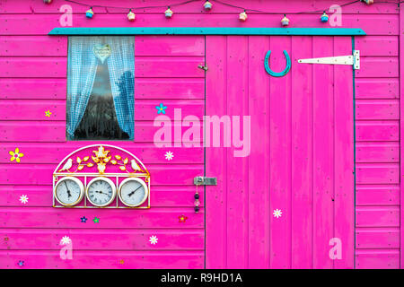 Pink garden shed with curtains and barometer, Kilwinning, Ayrshire ...