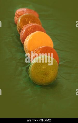 French Macaroon cookies in fall colors in green, yellow and orange laid ...