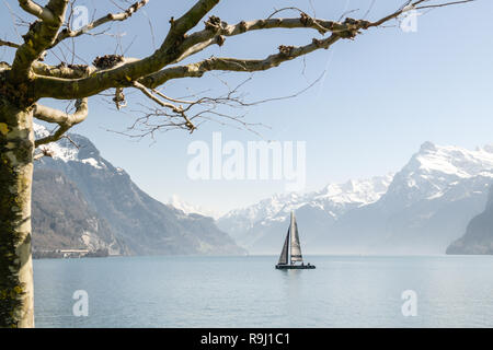 BRUNNEN, SWITZERLAND - APRIL 7, 2018: Small boat sailing on Lake ...