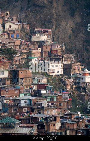 A hillside of slums in Shimla, Himachal Pradesh, India. At the top of ...