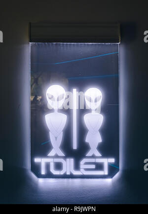 Illuminated alien sign, futuriistic alien toilet sign Stock Photo - Alamy